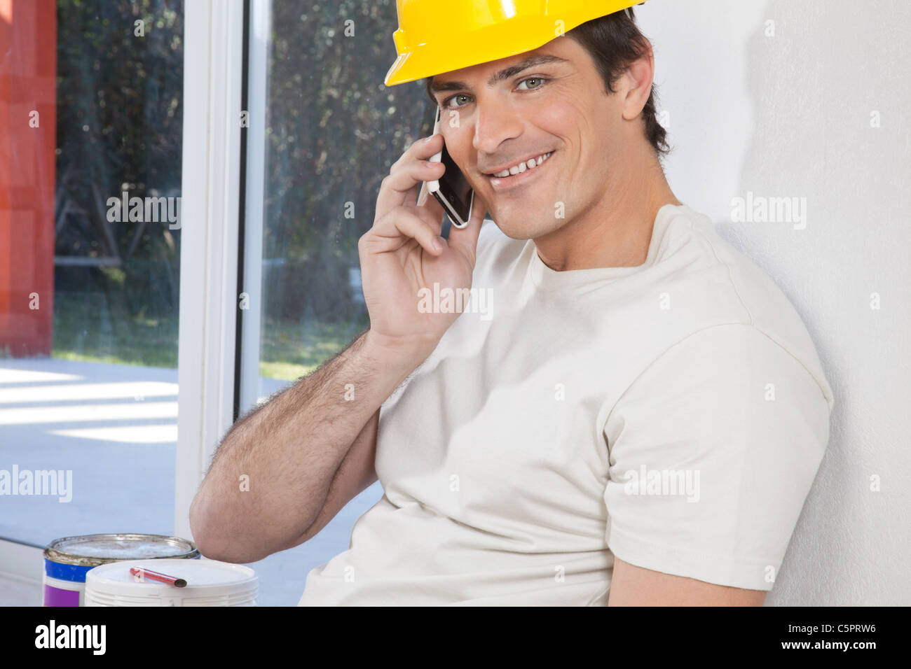 Portrait of construction worker talking on phone Stock Photo - Alamy