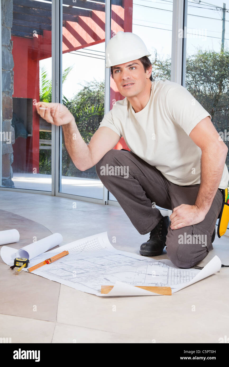 Construction worker concerned about the project Stock Photo - Alamy