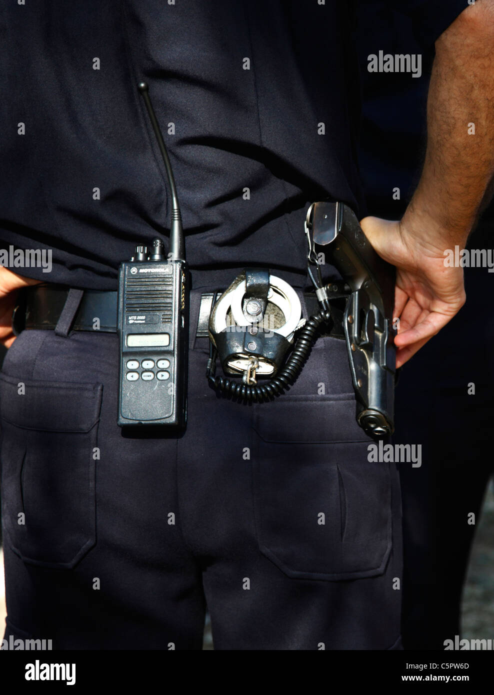 Rear view of an Israeli policeman with a pair of handcuffs a pistol and ...