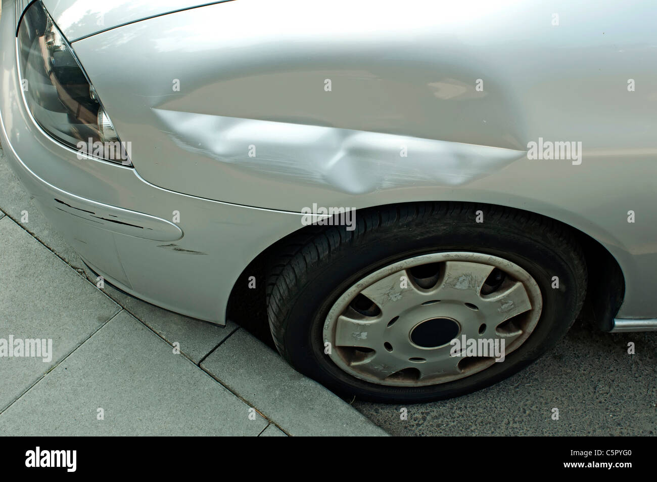 Scraped and crushed car fender Stock Photo - Alamy