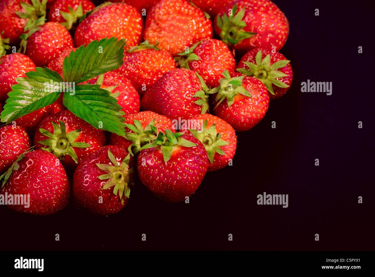 Strawberry on black background Stock Photo - Alamy