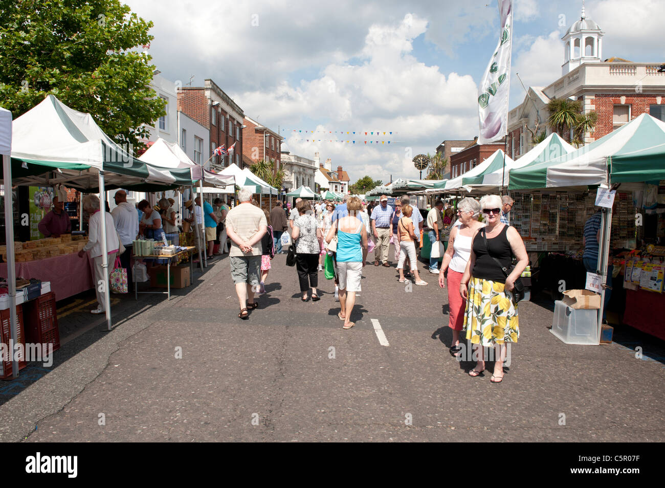 Shoppers stroll around a street market in Christchuch, Dorset, on a ...