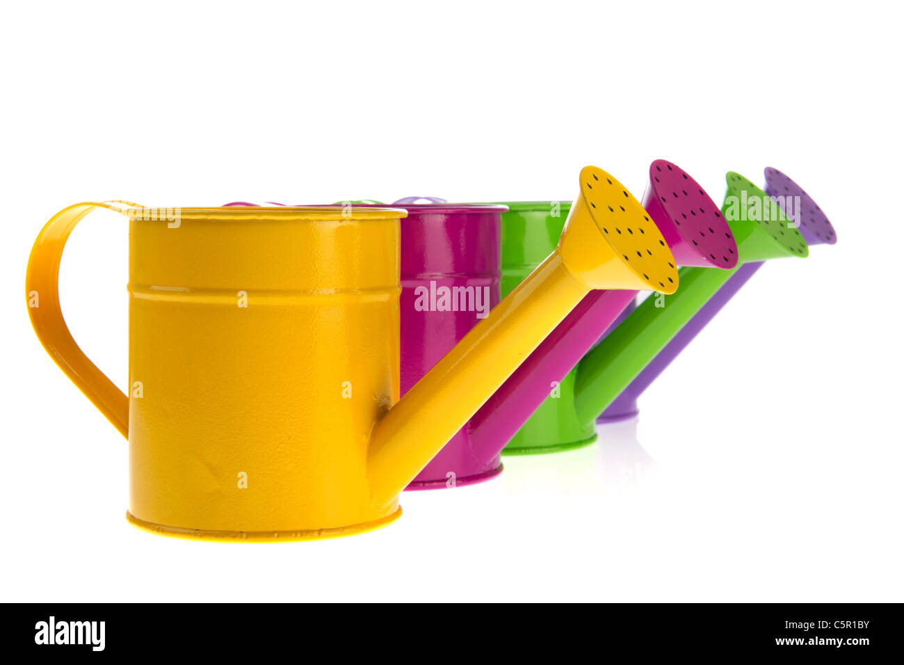 Row colorful watering cans for summer in the garden Stock Photo - Alamy