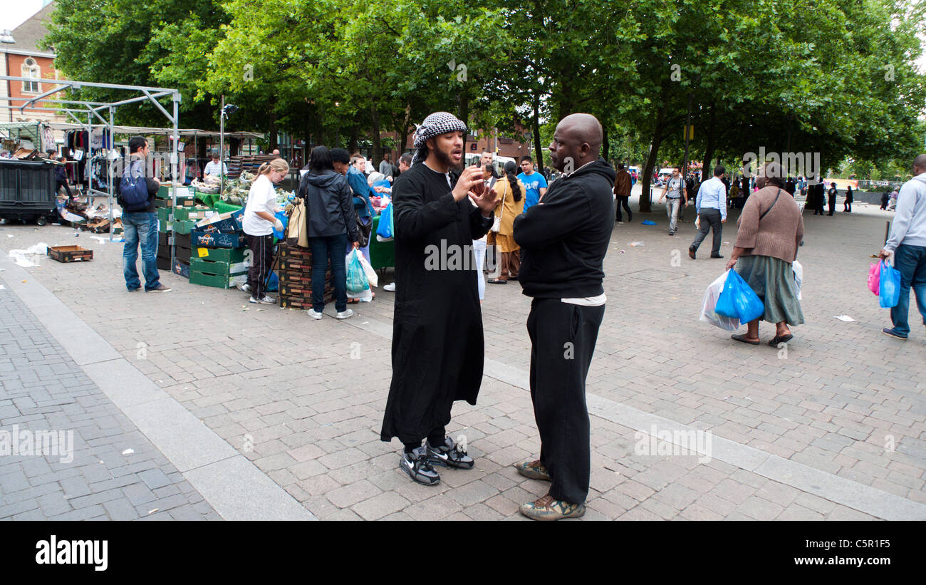 An Islamic preacher promoting Islam religion to a Christian believer ...