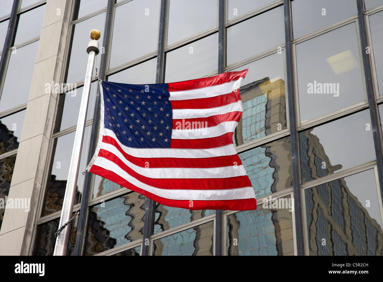 united states national flag flying outside office building in downtown ...
