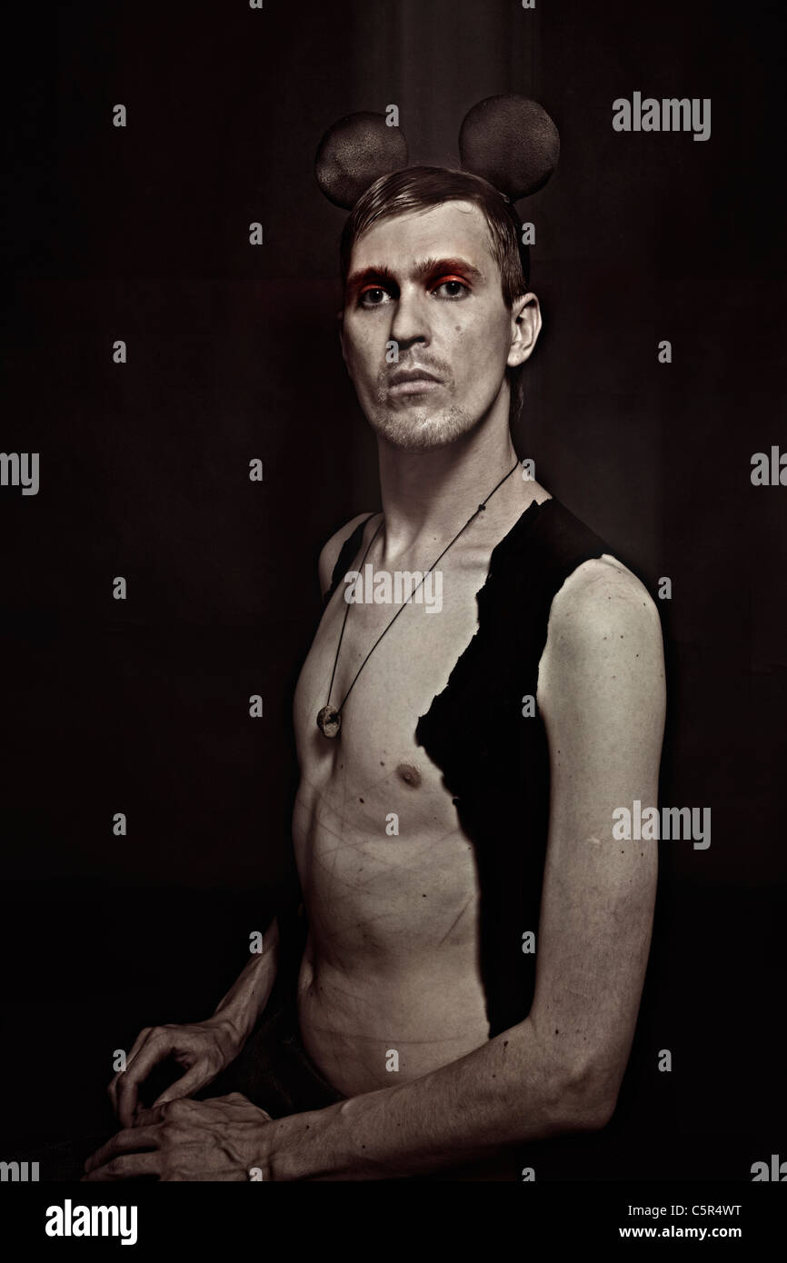 Portrait of a young man with a sham mouse ears Stock Photo - Alamy