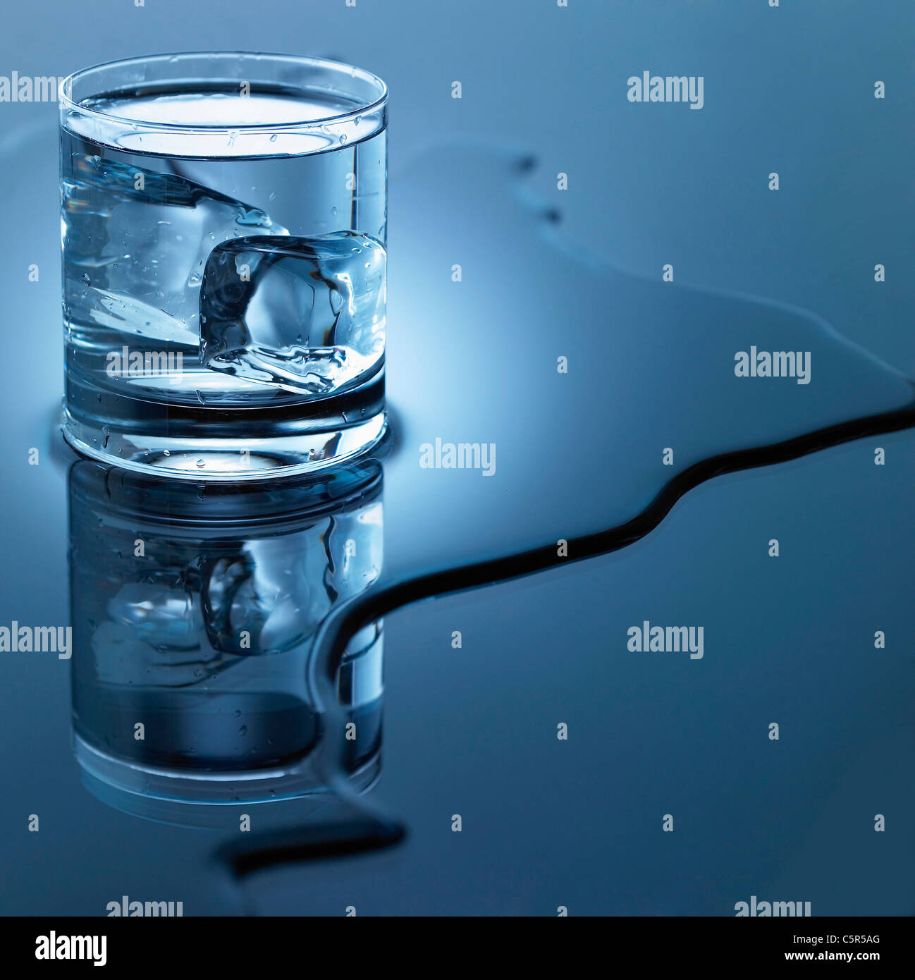 Water cup on spilled water Stock Photo - Alamy