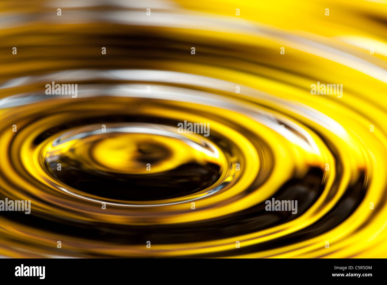 golden water waves created from drops of water and a gold background ...