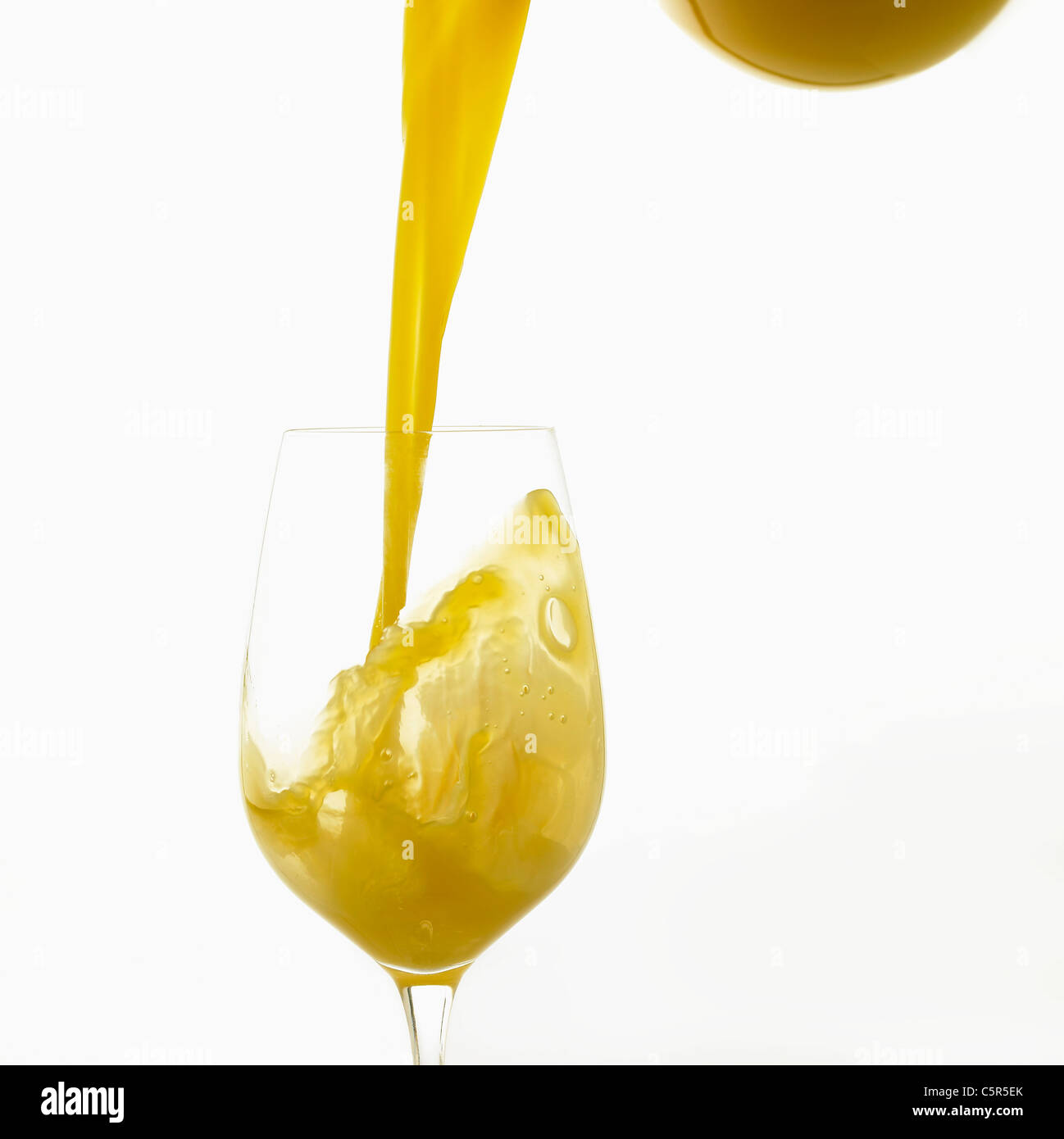 Orange juice pouring down to a glass Stock Photo - Alamy