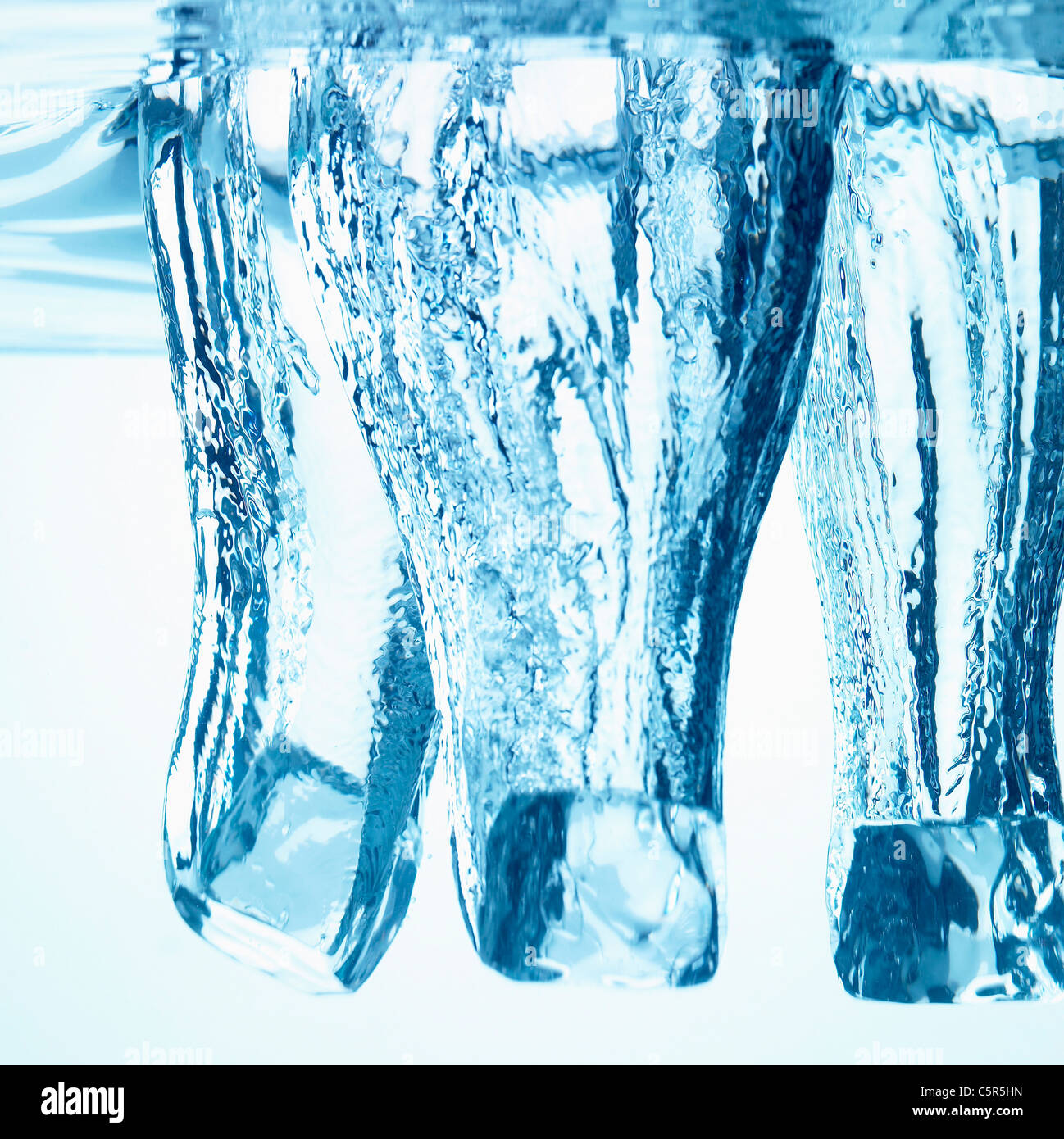 Ice cubes falling into water Stock Photo - Alamy