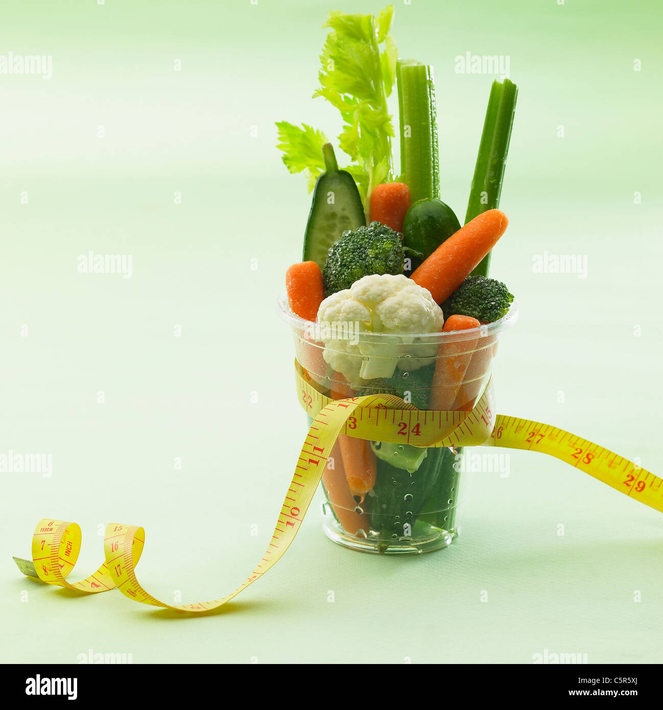 A measuring tape around cup of vegetables Stock Photo - Alamy