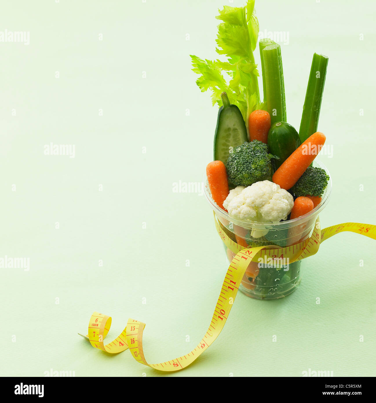 A measuring tape around cup of vegetables Stock Photo - Alamy