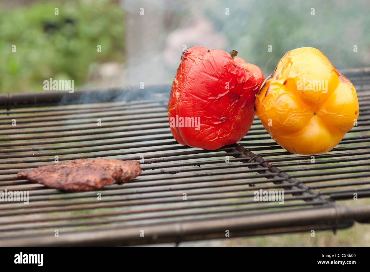 Two peppers on barbecue grill rack Stock Photo - Alamy