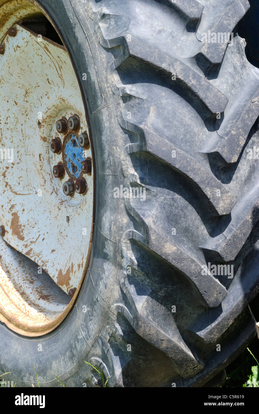 Close up of tractor tyre (tire) on old rusty wheel Stock Photo - Alamy