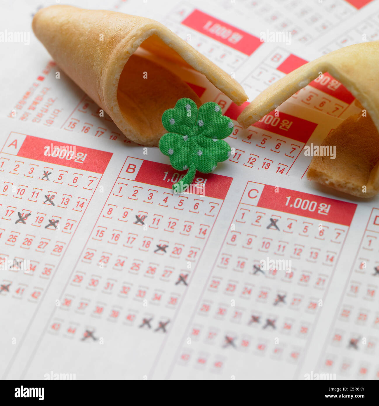 A four leaf clover in a fortune cookie and lottery tickets Stock Photo ...