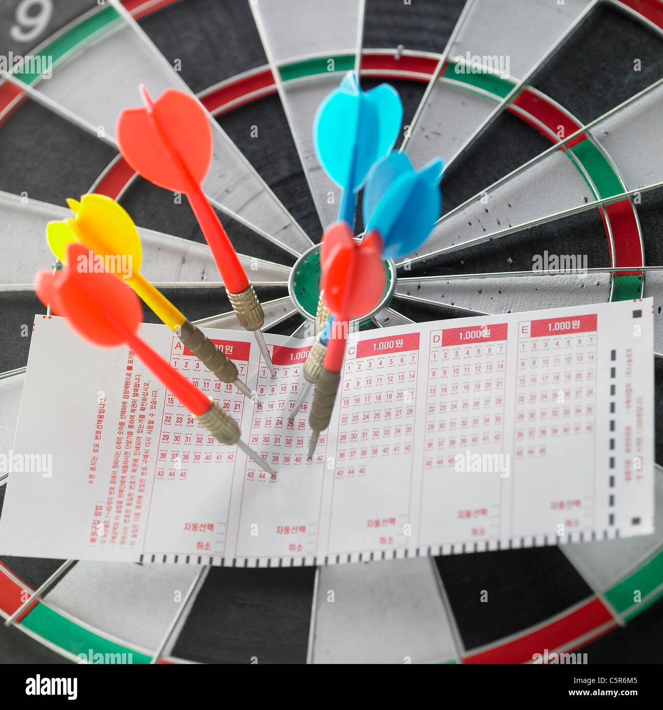 Lottery ticket put on a dart board Stock Photo - Alamy