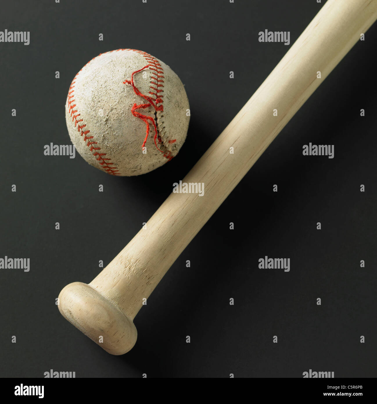 A bat and an old ball with its stitch ripped Stock Photo - Alamy