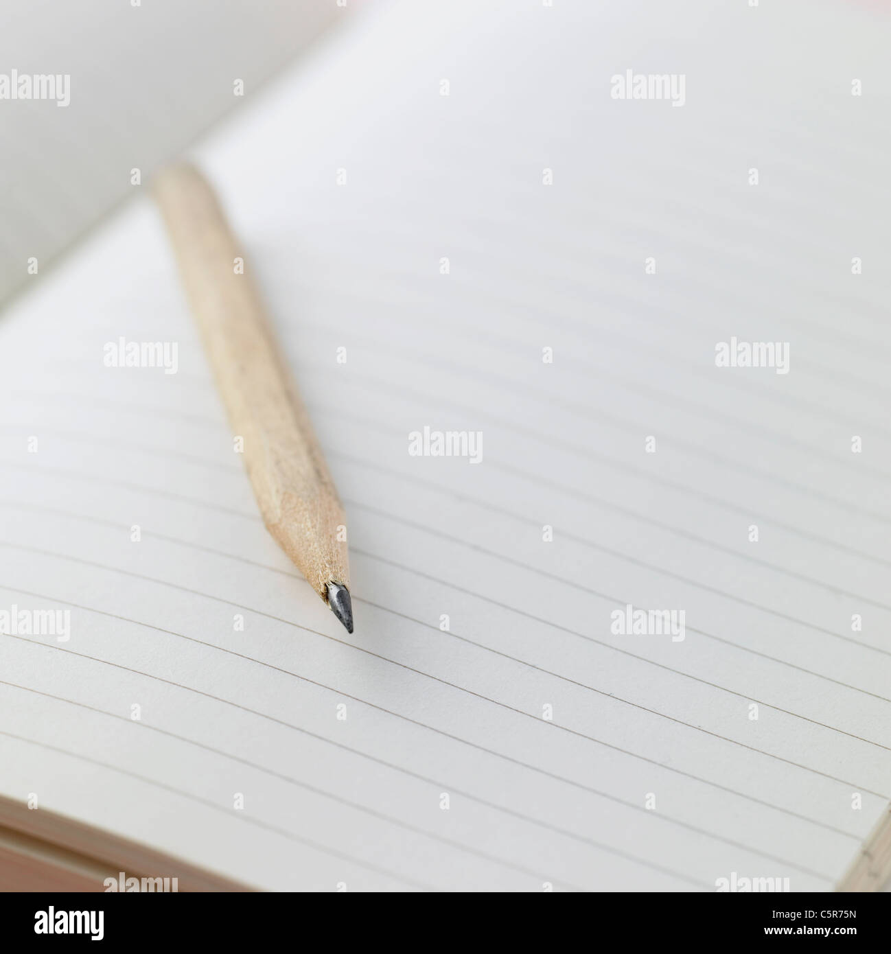 An open notebook and a pencil Stock Photo - Alamy