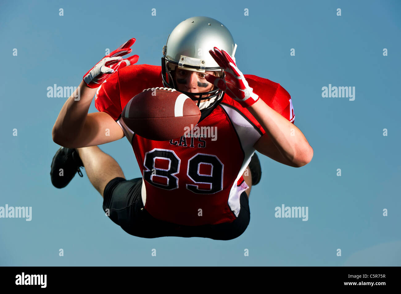 American footballer flying through air hi-res stock photography and ...