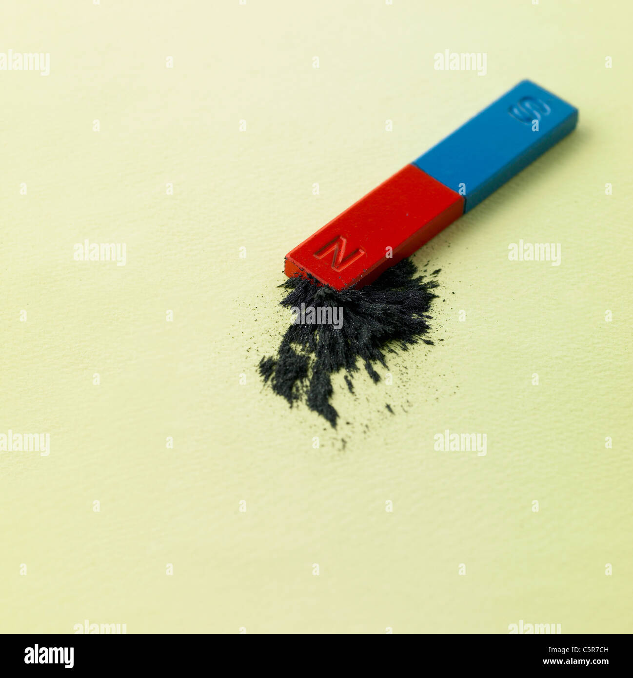 A magnet and iron powder Stock Photo - Alamy