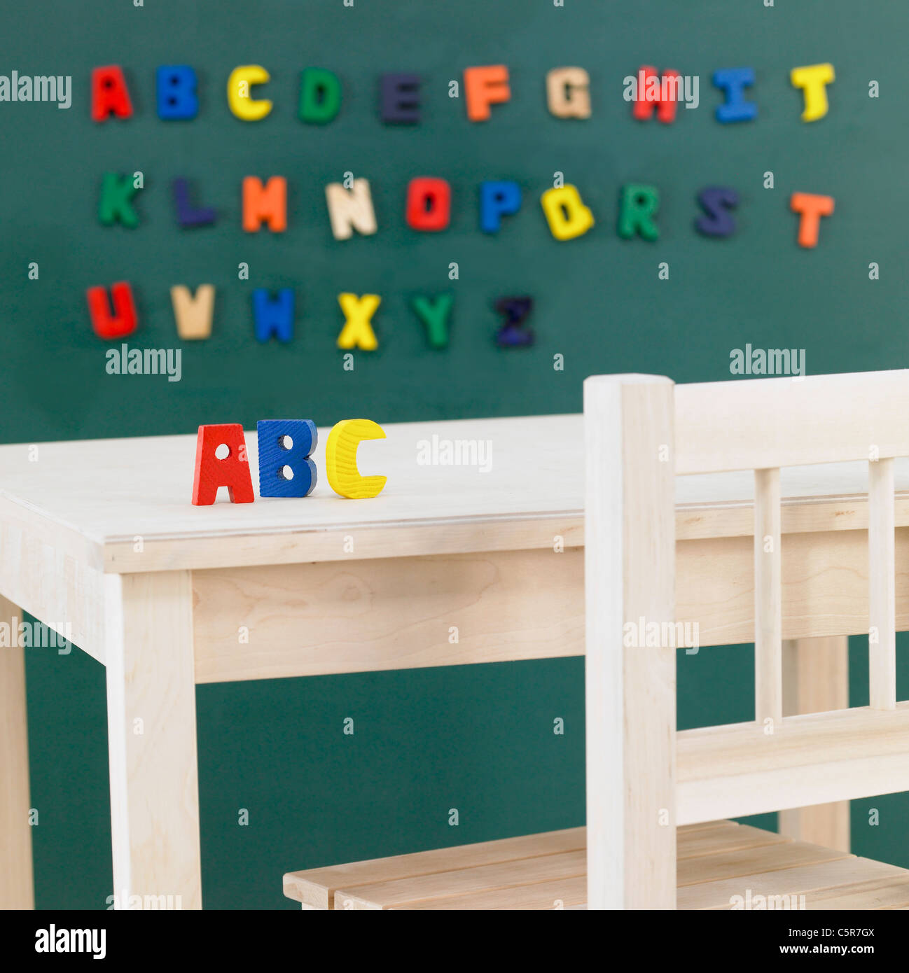 A desk, chair with alphabet letters Stock Photo - Alamy
