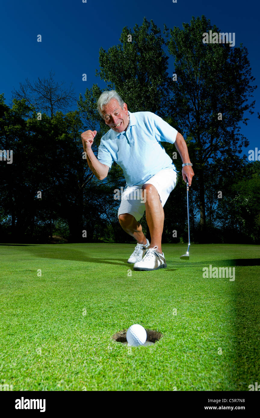 A golfer celebrates a successful putt Stock Photo - Alamy