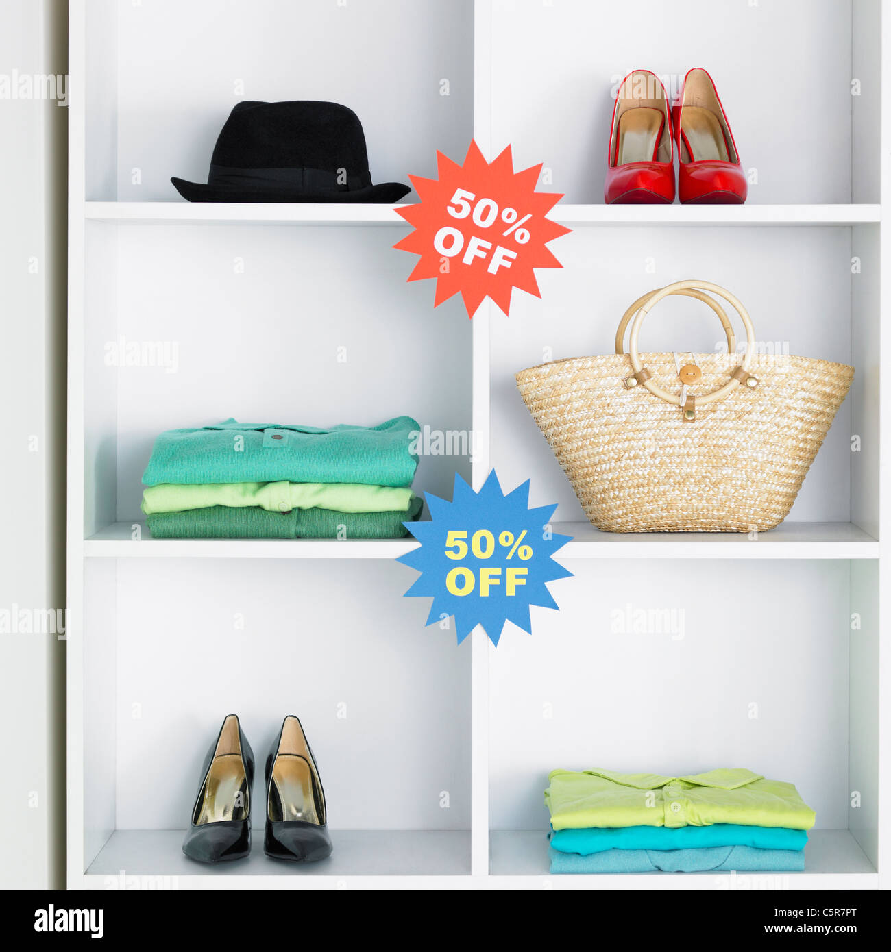 Goods displayed in showcase with discount signs Stock Photo - Alamy