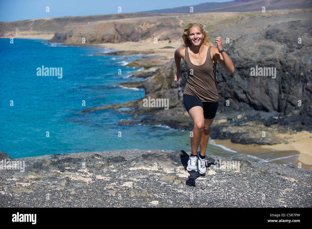 Young women jogging around Ocean Cliffs Stock Photo - Alamy