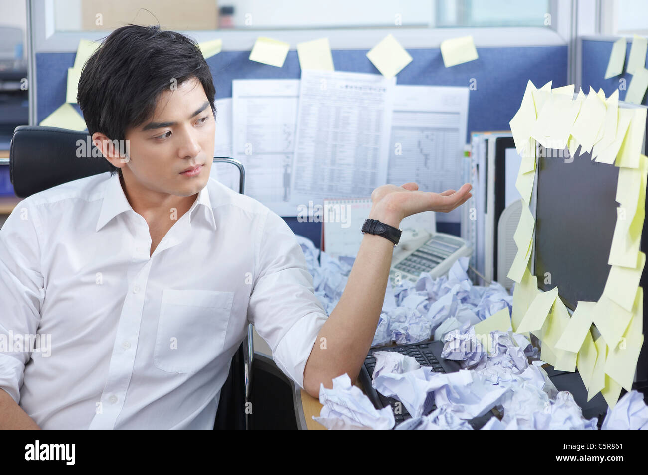 A business man sitting on a disordered desk Stock Photo - Alamy