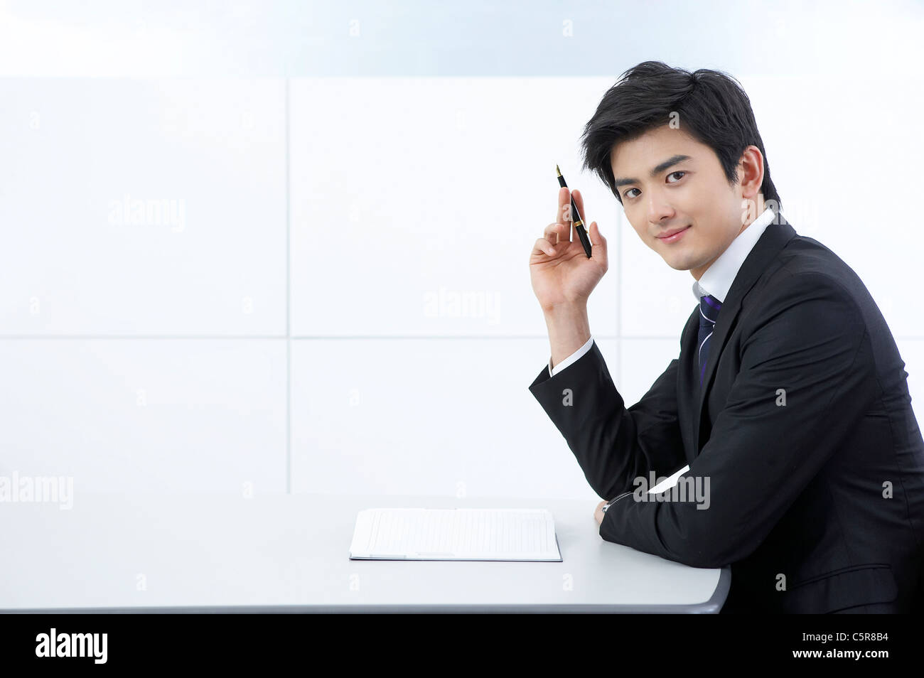 A man sitting at a table Stock Photo - Alamy