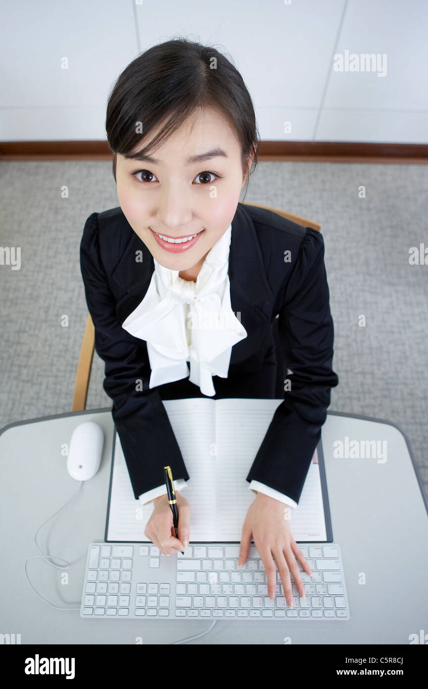 A business woman working at a table Stock Photo - Alamy