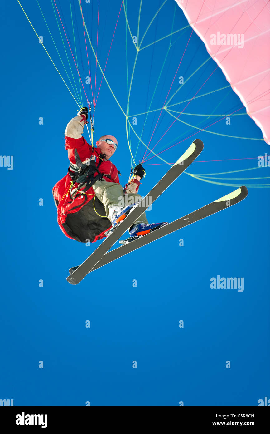A Paraglider pilot connected to his wing by the lines Stock Photo - Alamy