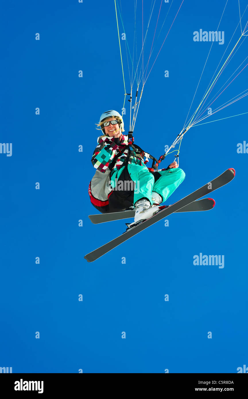 A female paraglider pilot smiles whilst flying past Stock Photo - Alamy