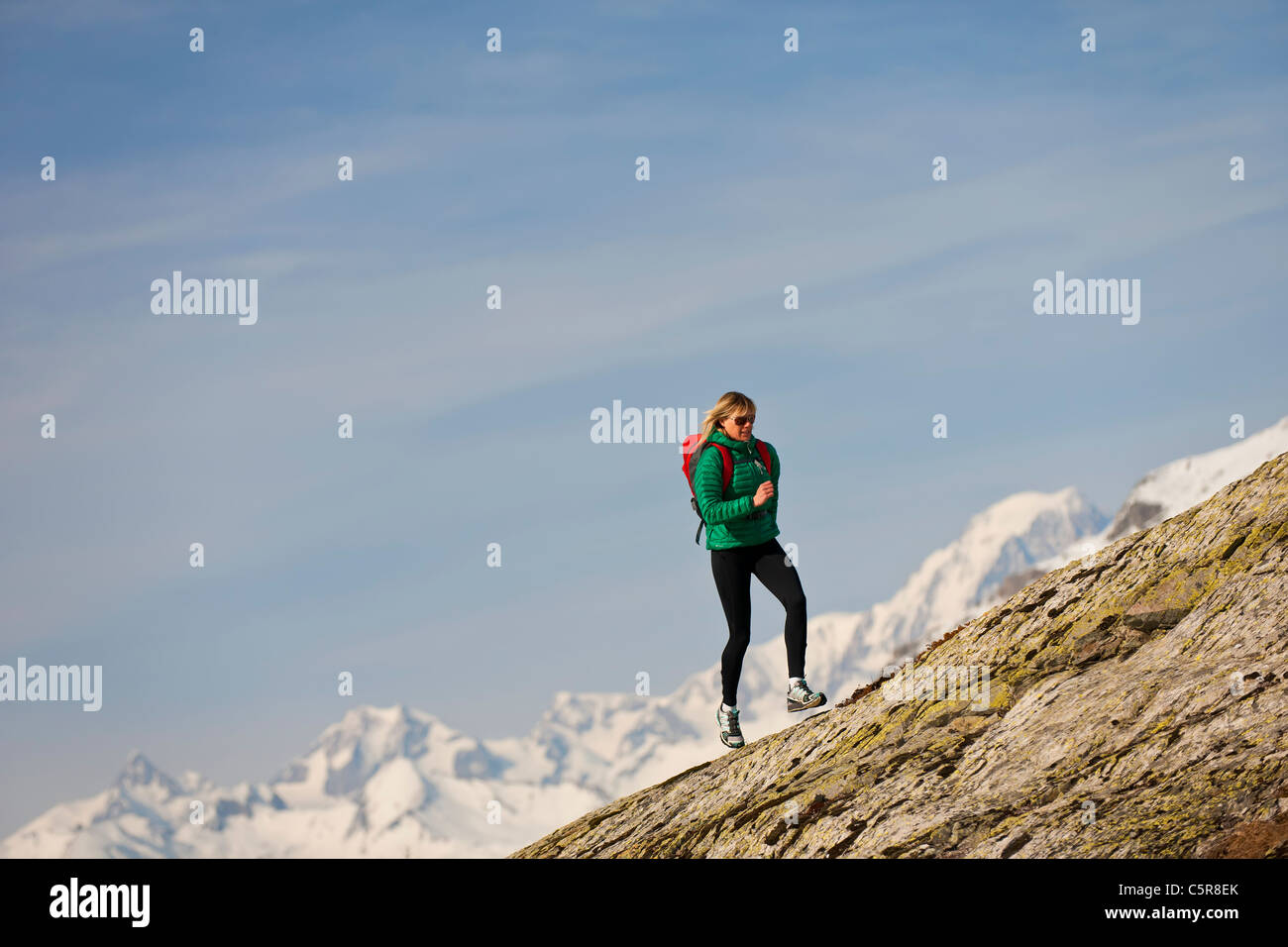 A runner runs over a rocky mountain Stock Photo - Alamy