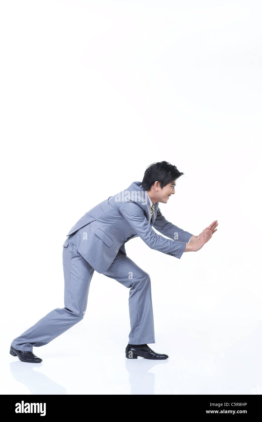 A business man stretching arms Stock Photo - Alamy