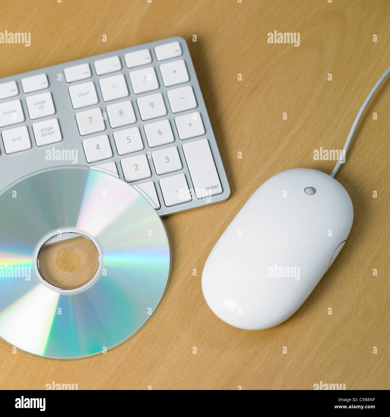 CD, keyboard and computer mouse on a desk Stock Photo - Alamy