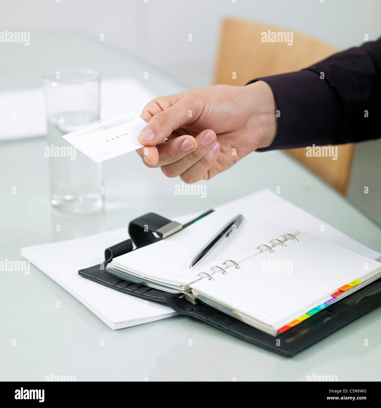 A person giving name card Stock Photo - Alamy