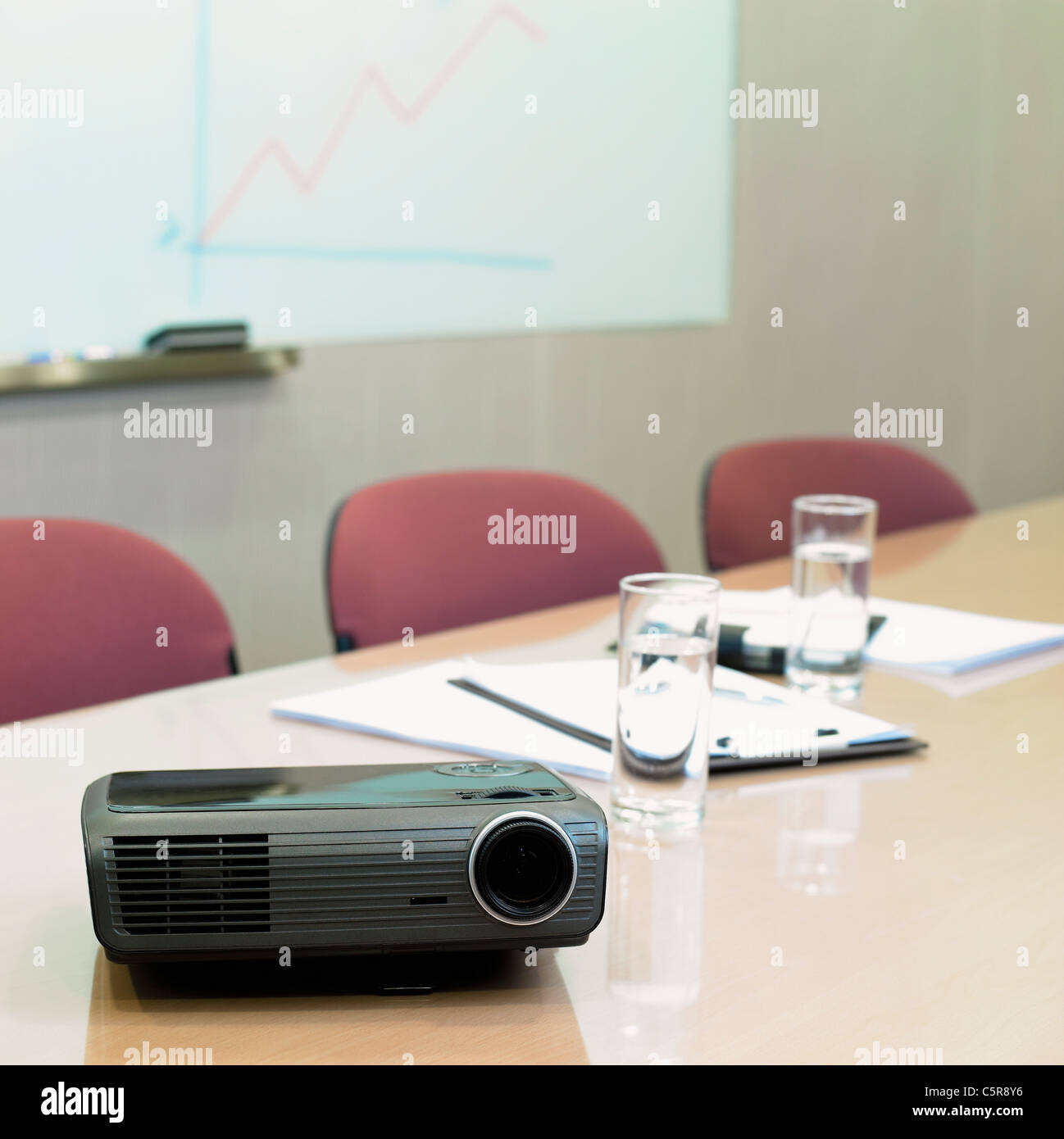 A projector and other things on meeting table Stock Photo - Alamy