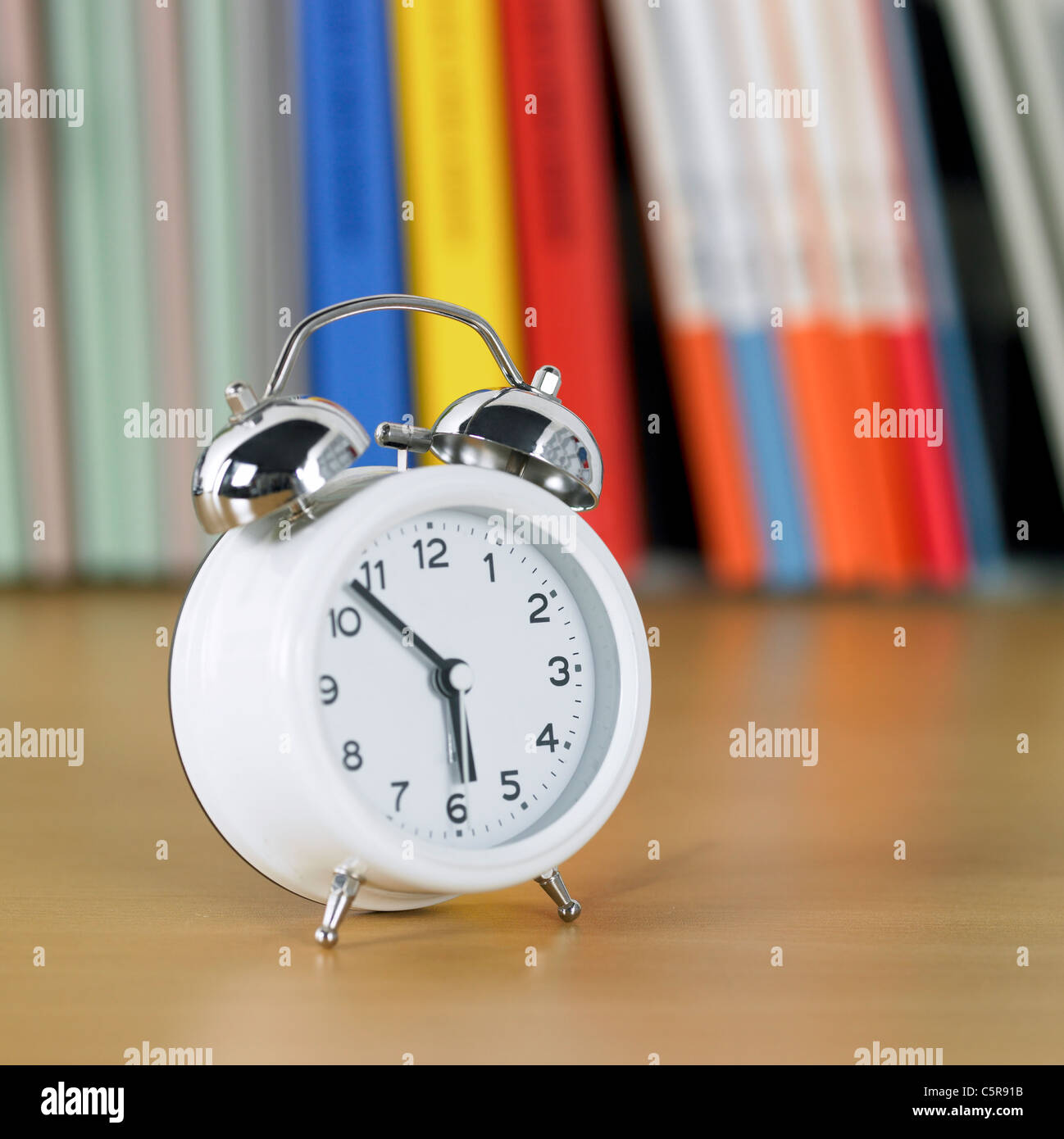 A clock on a desk Stock Photo - Alamy