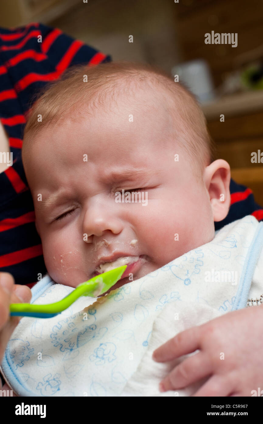 Four months old baby being spoon fed Stock Photo - Alamy