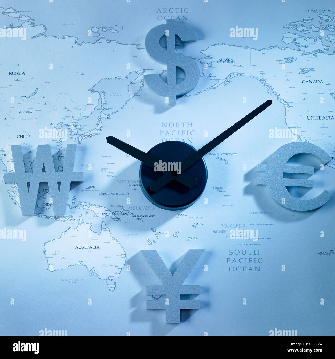 A clock with currency signs and map Stock Photo - Alamy