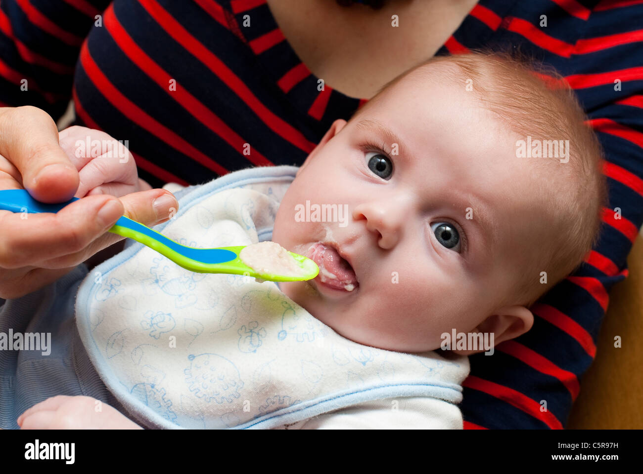 Four months old baby being fed with a spoon Stock Photo - Alamy