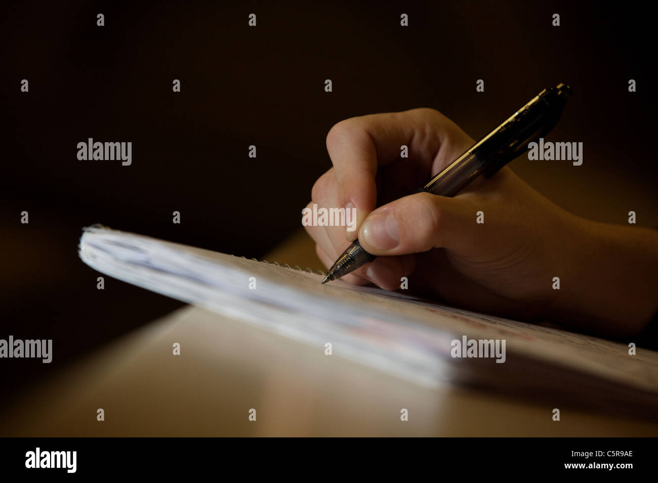 Pen poised to write on a notepad Stock Photo - Alamy
