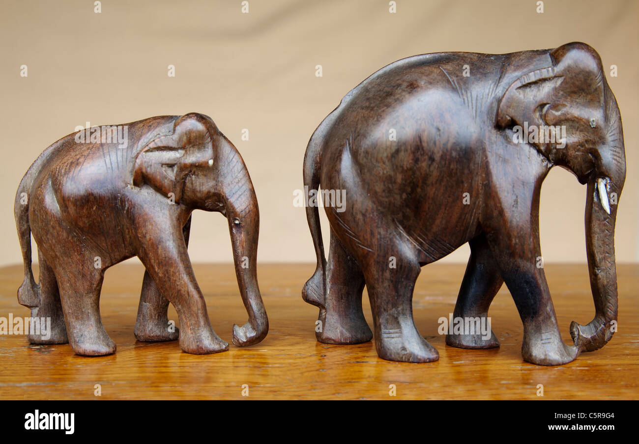 Hand carved from mango tree dark wood with ivory detail on an oak table ...