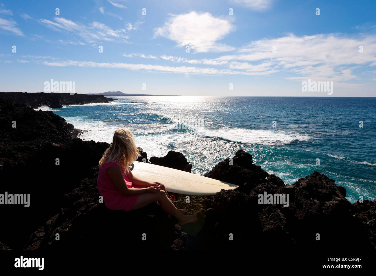 A surfer looks out over the Ocean Stock Photo - Alamy