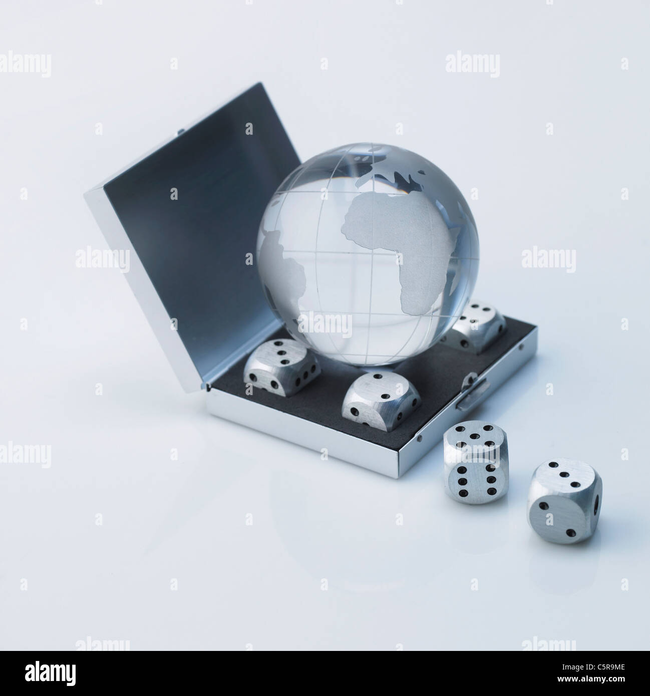 A globe inside a case with dice Stock Photo - Alamy