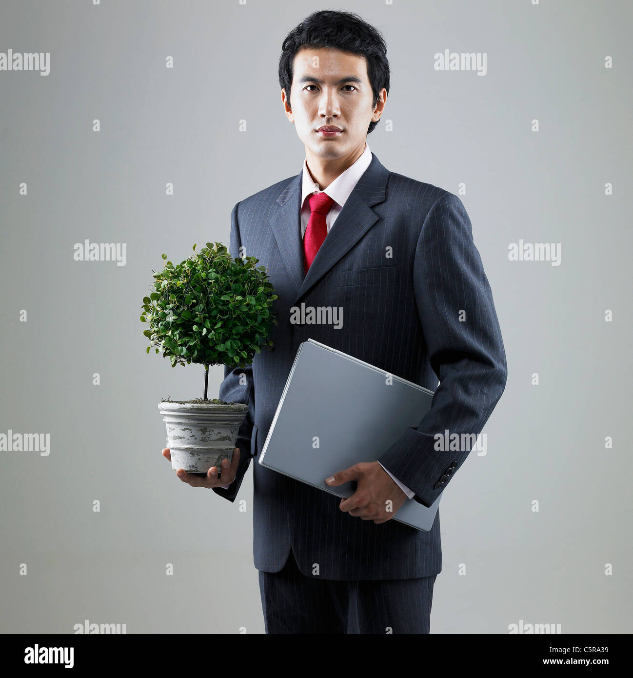 A man holding a flowerpot and a file Stock Photo - Alamy