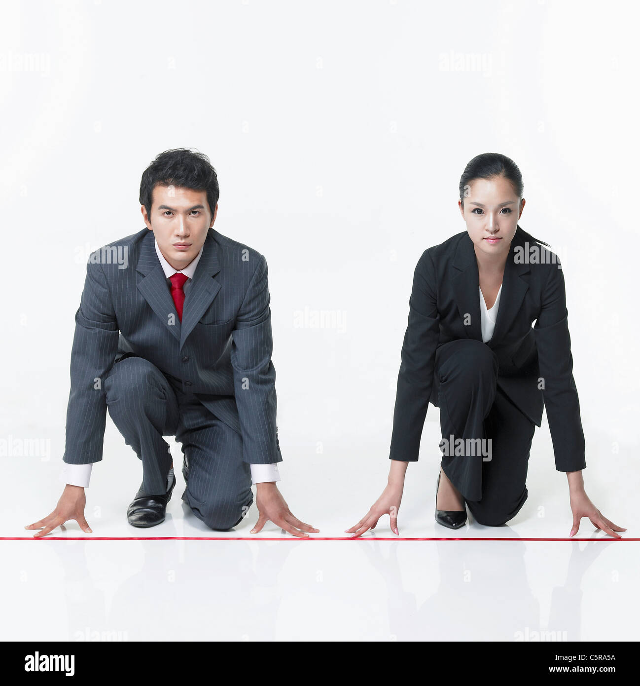 A woman and a man getting ready on start line Stock Photo - Alamy