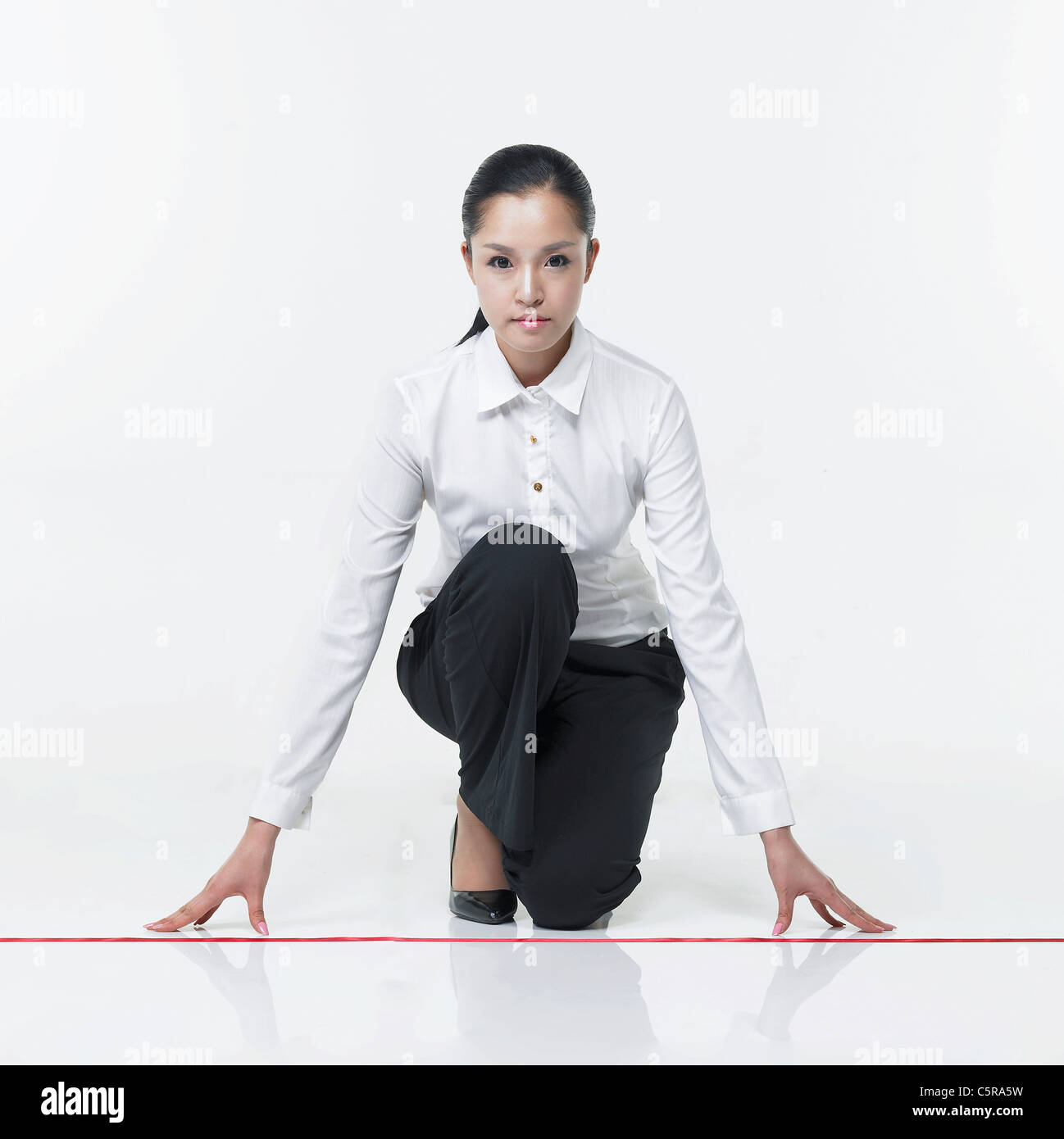 A woman getting ready on a start line Stock Photo - Alamy