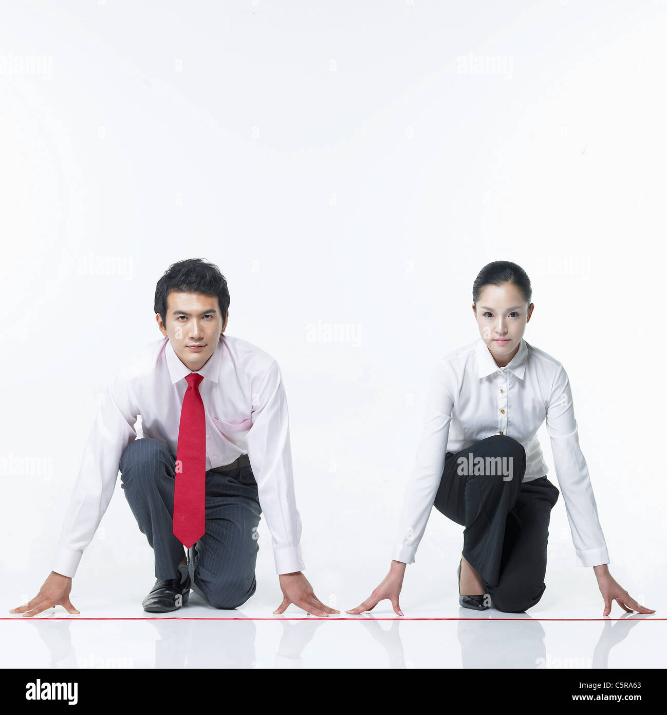 A woman and a man getting ready on start line Stock Photo - Alamy